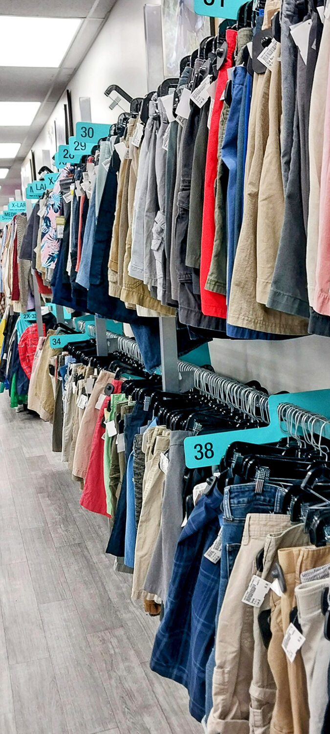 The shorts section is meticulously organized by size. Those blue tags aren't just numbers&mdash;they're your roadmap to pants that actually fit.