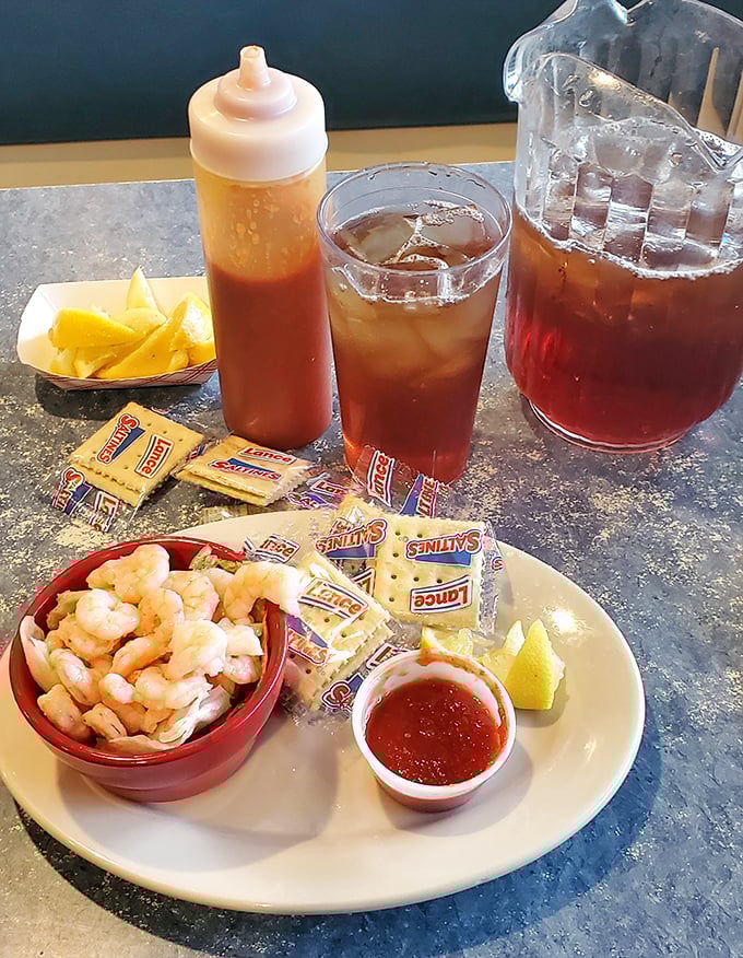 Shrimp cocktail simplicity: plump little jewels of the sea nestled in a crimson bath, with crackers standing by for the perfect bite.