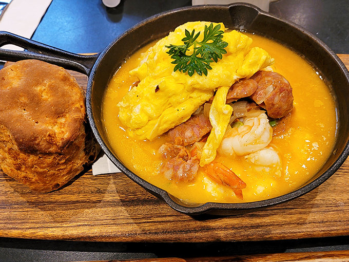 Shrimp swimming in creamy, sunshine-yellow grits with a biscuit standing by, ready to sop up every last bit of Southern-inspired heaven.