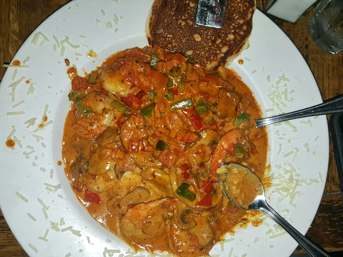 Shrimp and grits so creamy and flavorful they could make a New Orleans chef tip his hat. That cornbread on the side isn't just an afterthought.