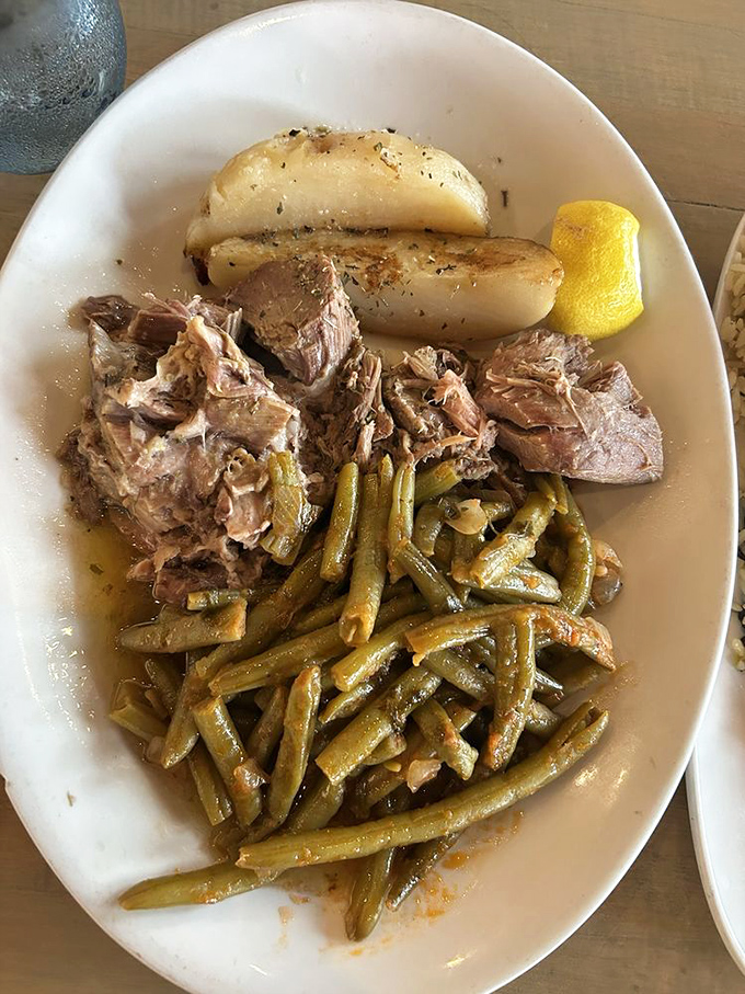 Slow-roasted lamb so tender it practically surrenders to your fork. Those green beans have been cooking with the meat juices&mdash;a vegetable transformed into something divine.