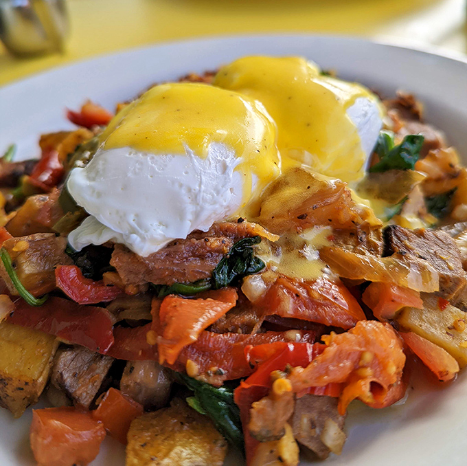 Poached eggs crown this mountain of smoked brisket hash like royal jewels atop a throne of breakfast perfection.