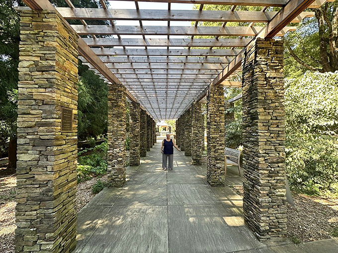 Walking through this stone pergola feels like stepping into an architectural marriage between Tuscany and the Carolinas.