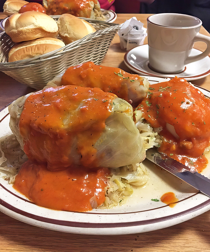 These stuffed cabbage rolls aren't just food&mdash;they're edible history, wrapped in tender leaves and smothered in a tomato sauce that could make a vegetarian reconsider.