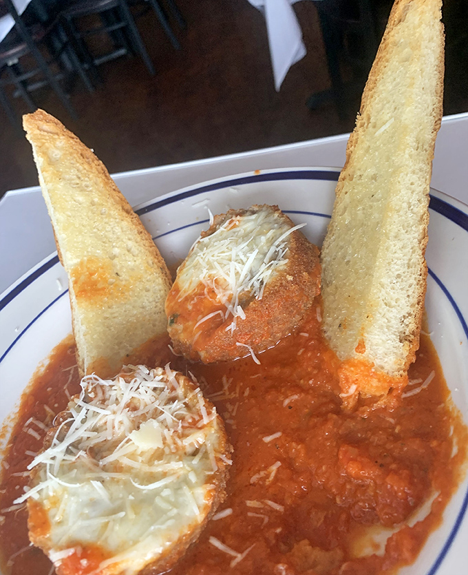These meatballs swimming in marinara with garlic bread soldiers standing guard deserve their own fan club immediately.