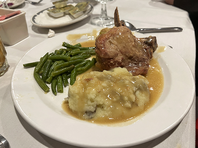 When a pork chop gets the royal treatment &ndash; tender meat bathed in savory gravy alongside mashed potatoes and green beans that actually taste like vegetables should.