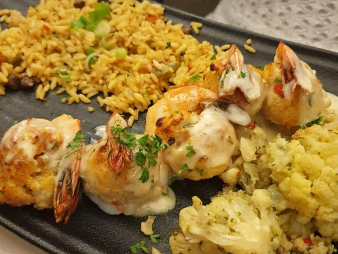 These stuffed shrimp aren't just seafood&mdash;they're little boats of flavor sailing across a sea of perfectly seasoned rice and cauliflower.