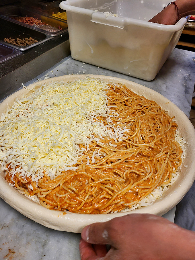 Half pasta, half pizza, all genius. This spaghetti-topped creation answers the eternal question: "Why choose when you can have both?"