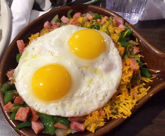 The Sierra Sunrise skillet doesn't just feed you—it prepares you for mountain adventures with perfectly cooked eggs crowning a colorful medley below.