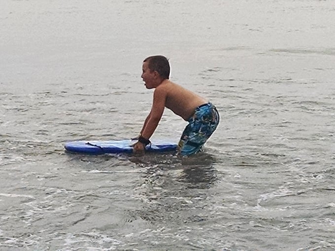Future surfing champion or just having the time of his life? In these waters, the distinction hardly matters when joy is the ultimate prize.