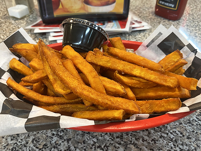 Sweet potato fries that achieve the impossible trifecta: crispy exterior, fluffy interior, and a natural sweetness that makes you wonder why regular potatoes get all the glory.