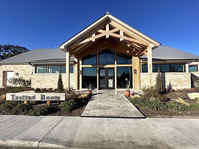 The tasting room combines Hill Country limestone with soaring wooden beams – like a barn designed by someone with exceptionally good taste.