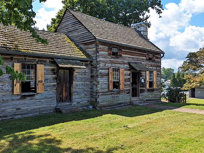 This historic log cabin at the Crockett Tavern Museum whispers tales of frontier life, when "open concept" meant your roof might have a few holes.