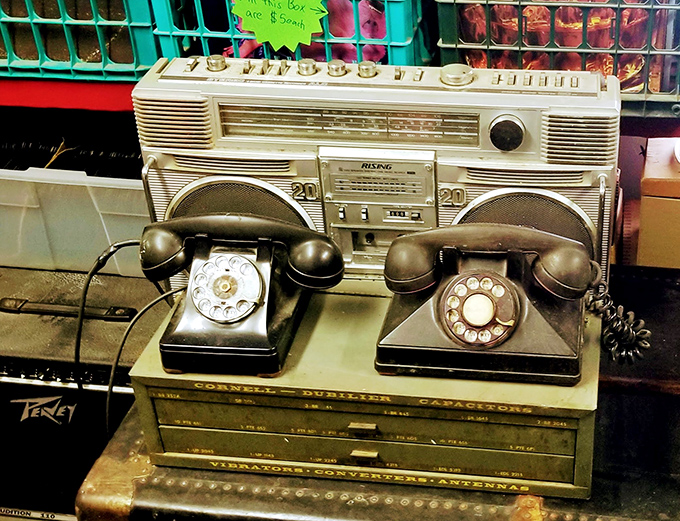 Communication evolution on display! Rotary phones sitting atop vintage electronics&mdash;when calling someone required commitment and good finger strength.