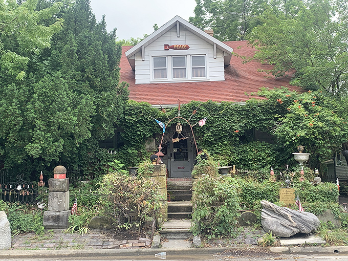 The Temple of Tolerance peeks through lush greenery, a quirky cottage where curiosity and charm grow as wild as the ivy.