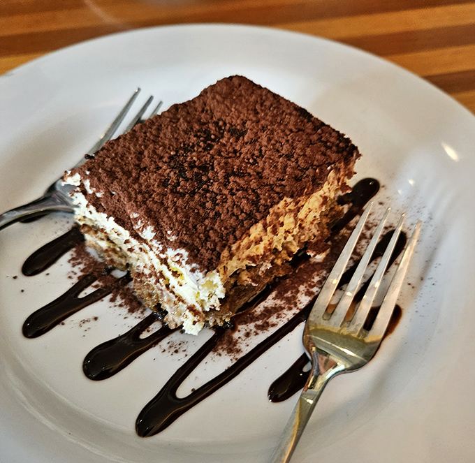 Tiramisu that strikes the perfect balance between coffee-soaked decadence and cloud-like mascarpone. The chocolate drizzle is just showing off.