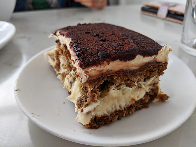 This isn't just tiramisu; it's a stratified masterpiece of coffee-soaked bliss that would make your Italian grandmother weep with pride.