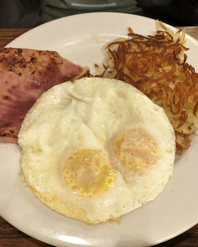 The breakfast trifecta: perfectly cooked eggs, Danish-style ham, and those gloriously crispy hash browns that somehow make Monday mornings bearable again.
