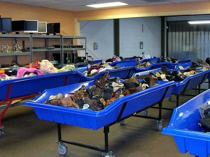 Blue bins overflow with handbags and accessories, proving one person's "maybe later" is your "absolutely now."