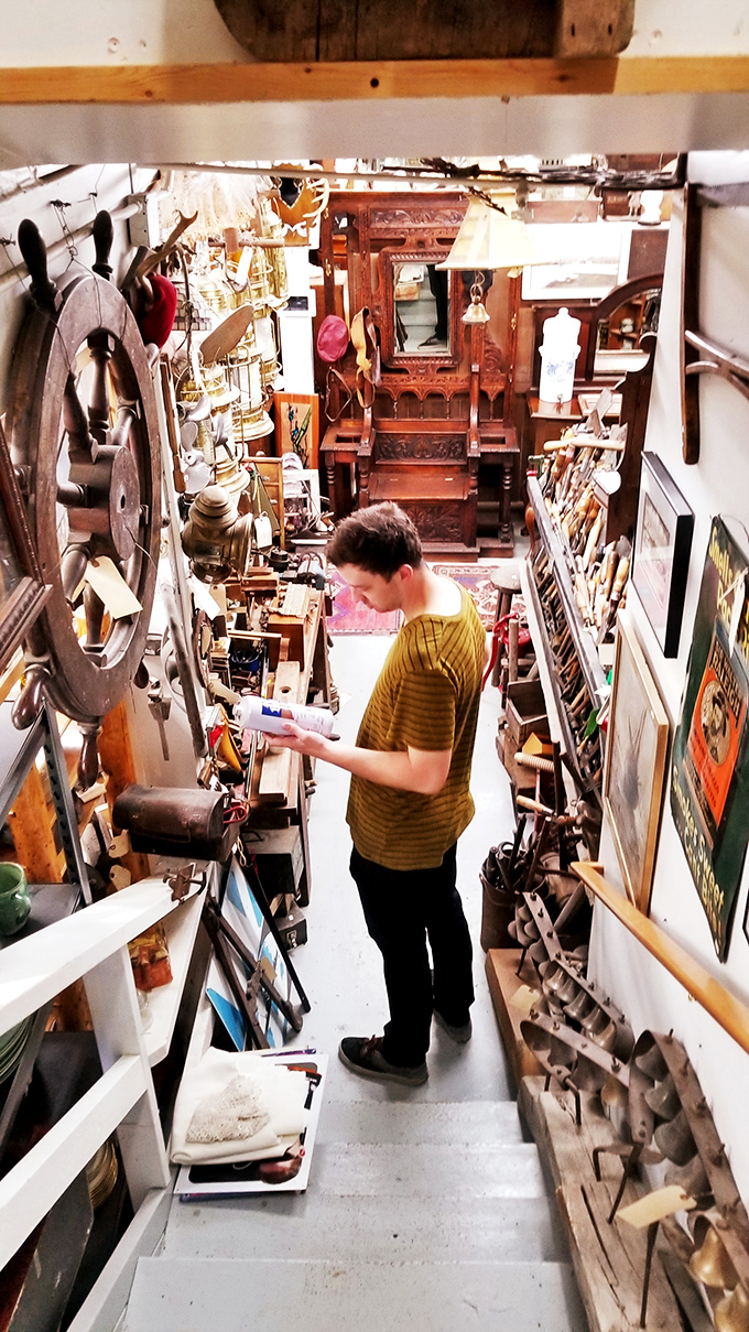 A young explorer navigates the narrow stairway of wonders, where every turn reveals another decade's worth of forgotten treasures.