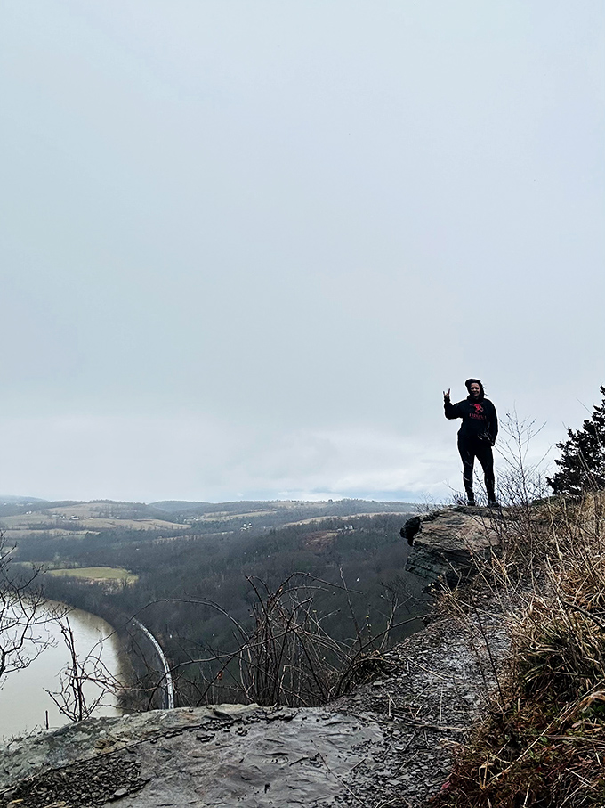 The universal "I'm on top of the world" pose never gets old when you've actually found a spot that feels like the top of the world.