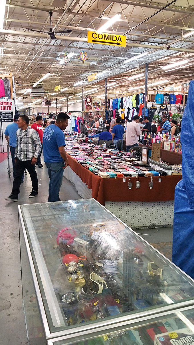Under the "COMIDA" sign, shoppers navigate a sea of merchandise. It's like a real-life version of Where's Waldo, but everyone's hunting bargains.
