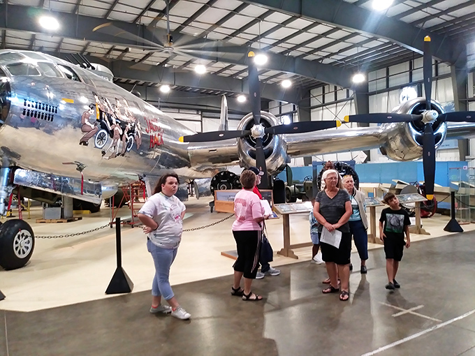 Multi-generational families gather beneath the polished aluminum of a vintage bomber. Nothing brings people together quite like standing under several tons of historic aircraft.