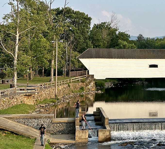 The bridge isn't just a historical landmark; it's part of daily life, with locals enjoying the adjacent park and waterfall steps on sunny afternoons.