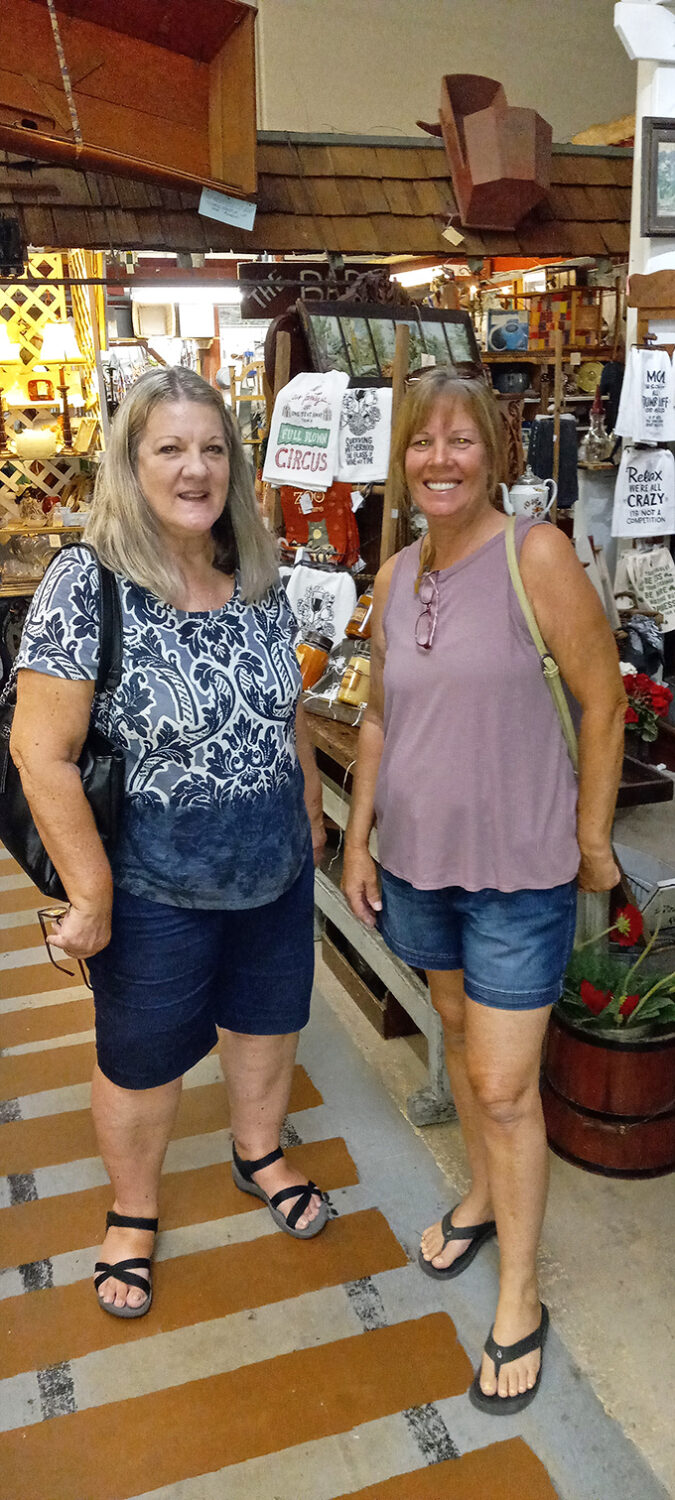 The interior of Granny's Attic reveals shoppers enjoying the thrill of the hunt among countless treasures and vintage finds.