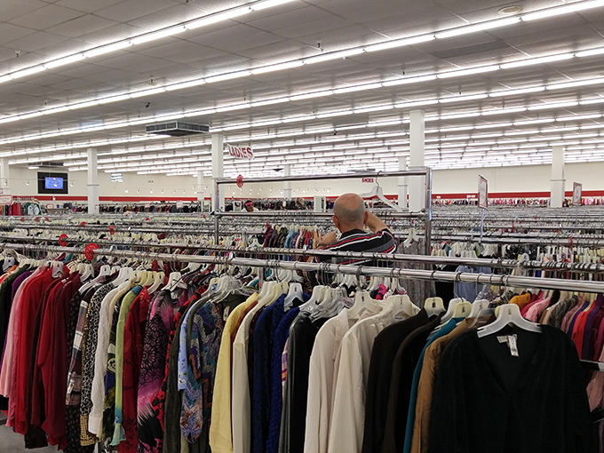The clothing section is so vast and well-organized that shoppers develop a strategy. Notice how everyone has the focused gaze of someone hunting for buried treasure.