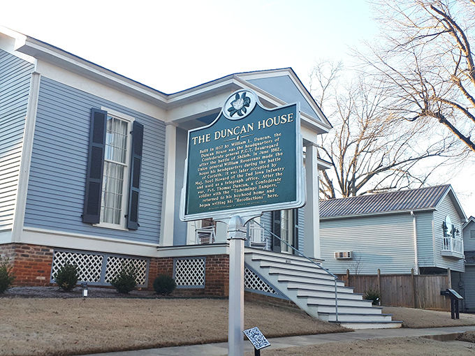 The Duncan House whispers stories of Civil War generals and antebellum dreams through its classic blue clapboard and historical marker.