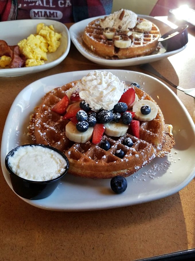 Fruit and waffle architecture at its finest—a masterpiece of crispy exterior, fluffy interior, and nature's candy on top. Whipped cream optional but highly recommended.