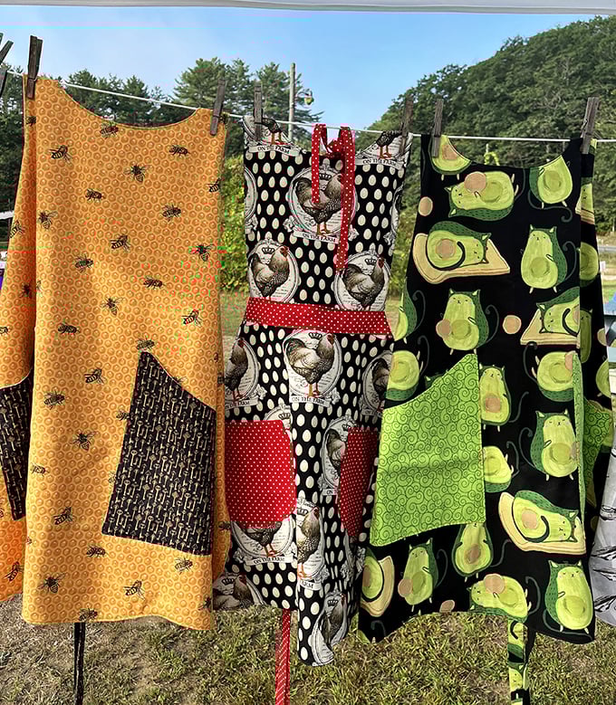 Kitchen fashion statements hanging in the breeze—from honeybees to roosters to avocados, these aprons prove cooking has never lacked personality in New England homes.