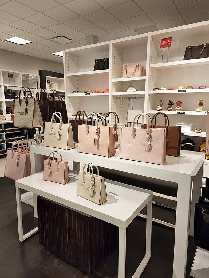Michael Kors handbags arranged with military precision, standing at attention like fashionable soldiers ready to march home with you at outlet prices.