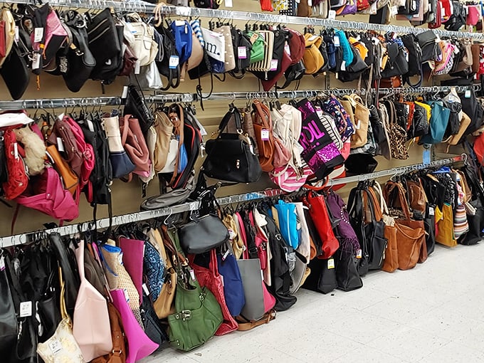 Handbag heaven! A rainbow of purses, totes, and clutches dangles in suspended animation, each one waiting to tell its second chapter.