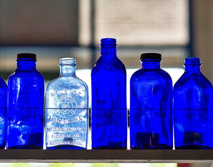 Blue bottle brigade standing at attention. That milk of magnesia bottle in the center probably cured more hangovers than we'll ever know.