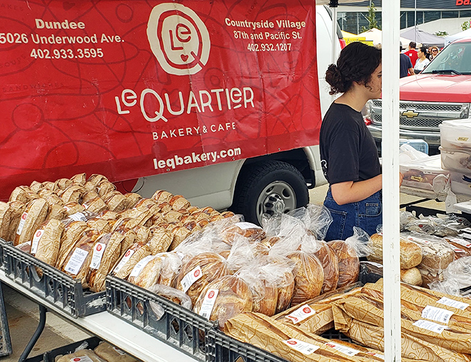 Le Quartier's artisanal loaves stand at attention like crusty soldiers, each one a testament to the ancient alchemy of flour, water, and time.