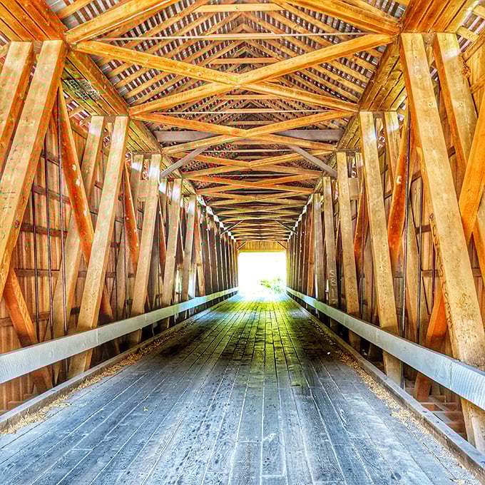 Inside the covered bridge, wooden beams create a cathedral-like passage that whispers tales of horse-drawn carriages.