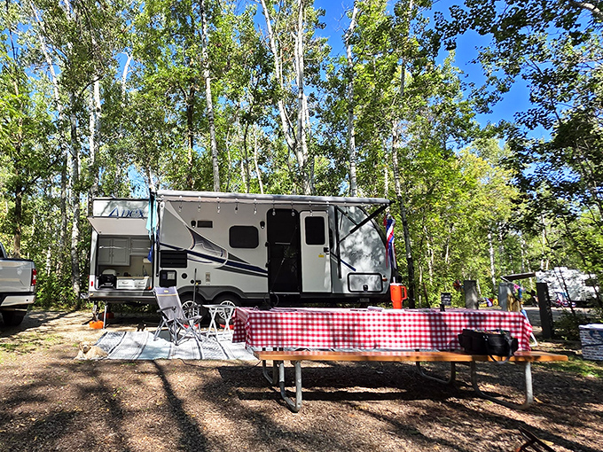 Camping goes upscale when your "tent" has wheels. That red-checkered tablecloth screams "I'm outdoorsy, but I still appreciate proper dining."