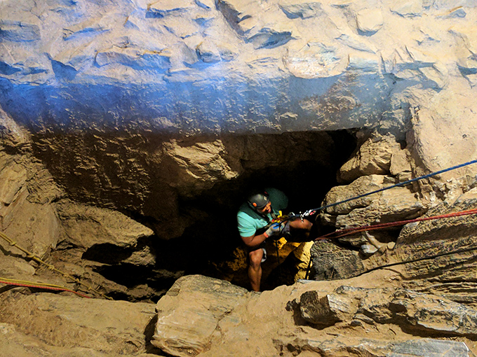 Spelunkers prepare to venture deeper into the cavern's mysteries. That helmet light isn't just for show &ndash; it's darker than your teenager's bedroom down there.