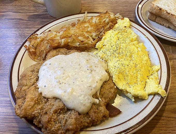 Country-fried steak smothered in gravy alongside perfectly scrambled eggs. This plate doesn't just feed you&mdash;it hugs your soul.