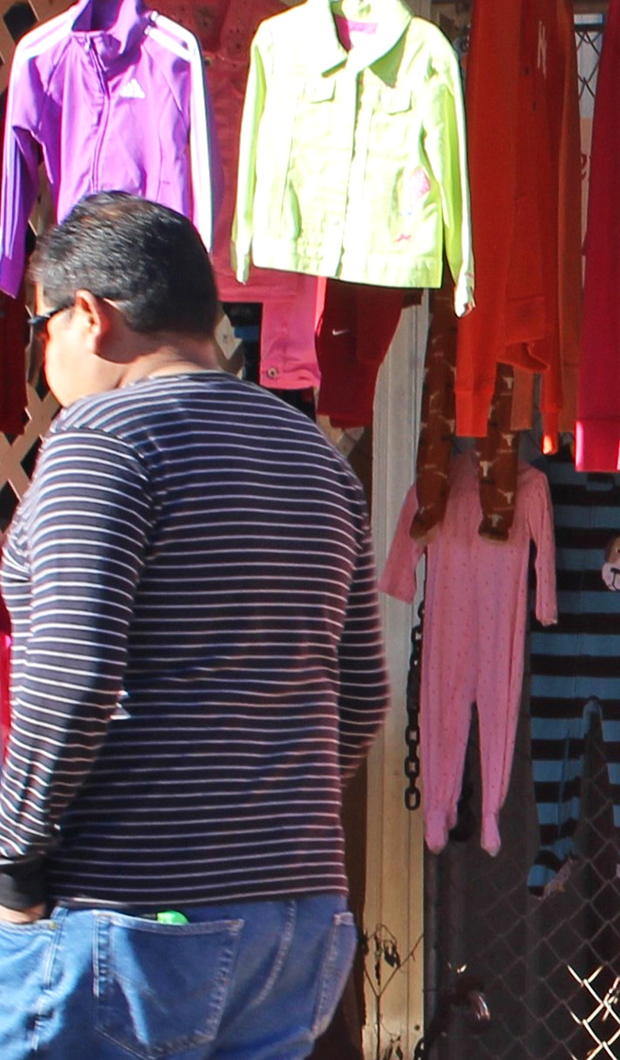 The serious business of browsing requires concentration. This shopper knows the perfect find might be hiding just behind that colorful rack.