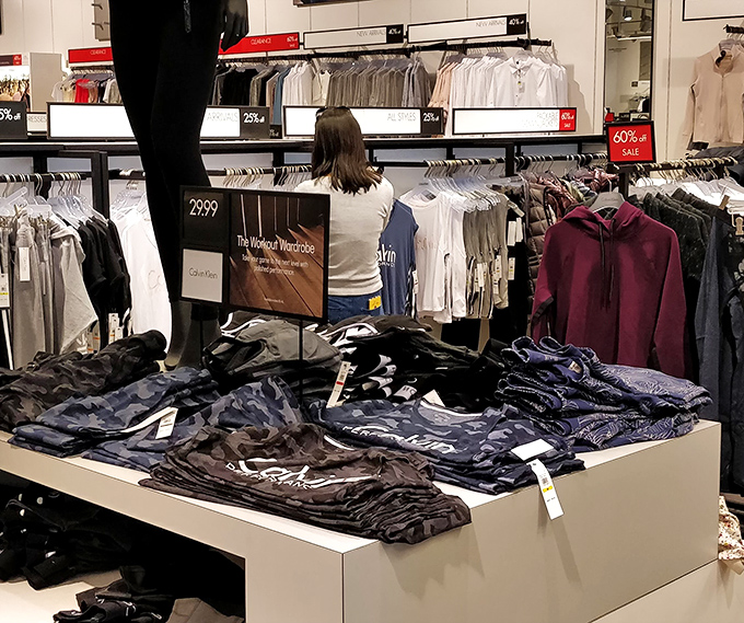 The universal language of outlet shopping: intense concentration while hunting for that perfect size among the sea of discounted treasures.