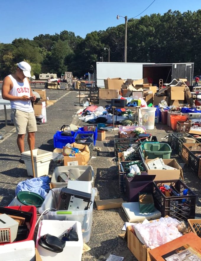 Cardboard box archaeology at its finest! Each container holds potential treasures, where patient shoppers dig for household items and unexpected gems among the everyday castoffs.
