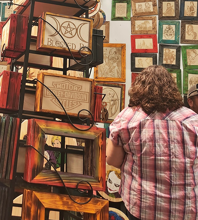 Handcrafted frames that tell stories—Harley-Davidson logos and mystical symbols sharing wall space like old friends at a reunion.