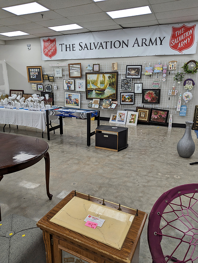 The wall of forgotten art where sailing ships and floral still-lifes find new admirers. Someone once loved these pieces enough to frame them – maybe you're next.