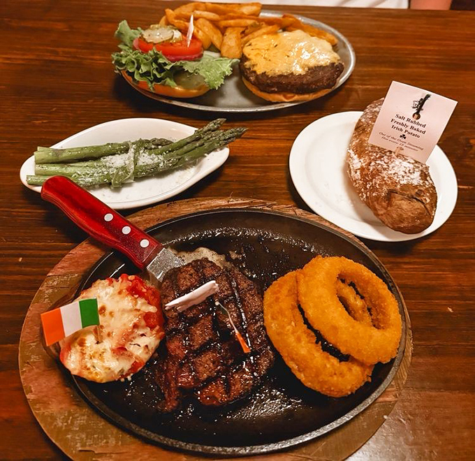 A carnivore's dream platter where steak meets onion rings in perfect harmony, with asparagus standing by as the token green representative at this meaty summit.