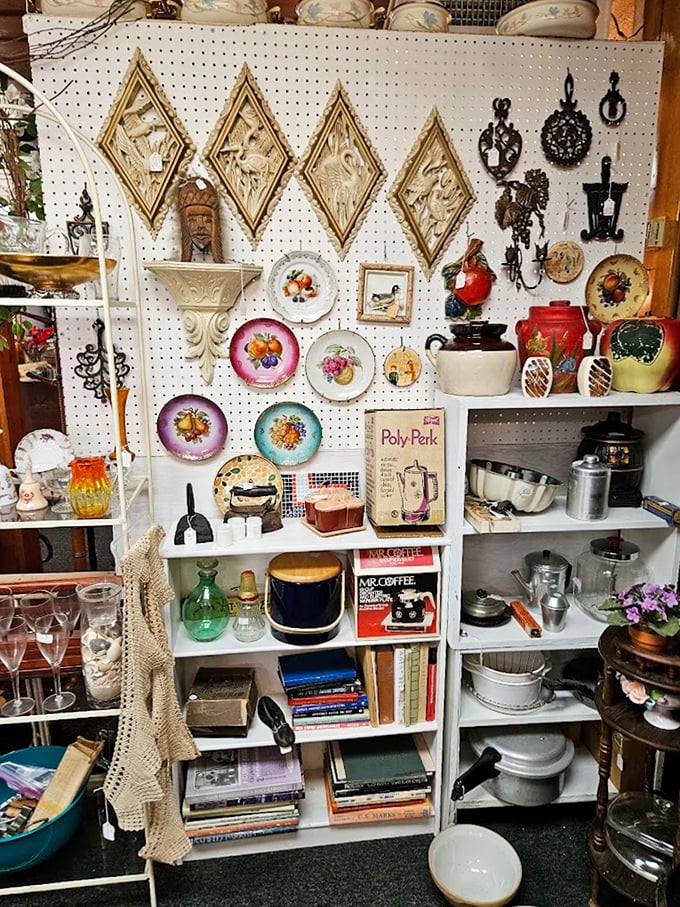 A pegboard paradise of decorative plates and kitchen collectibles. Those fruit-adorned dishes aren't just vintage &ndash; they're edible art from another era.