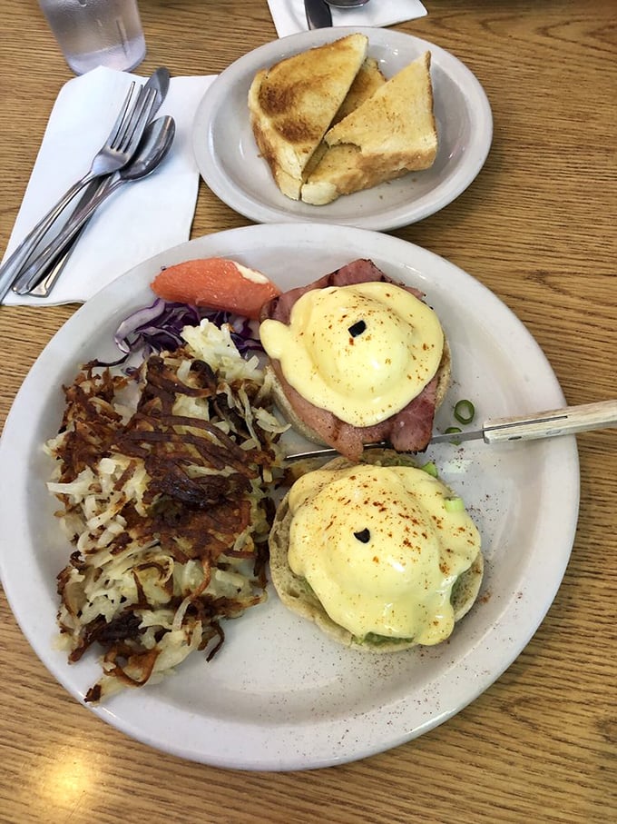 Behold, the holy grail of breakfast: Glo's legendary Eggs Benedict. Golden hollandaise cascades over perfectly poached eggs while those hash browns stand ready for their supporting role.