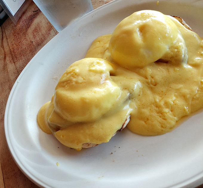 Eggs Benedict that would make a brunch enthusiast weep tears of hollandaise joy. That sauce blankets each English muffin like a silky, buttery cloud.